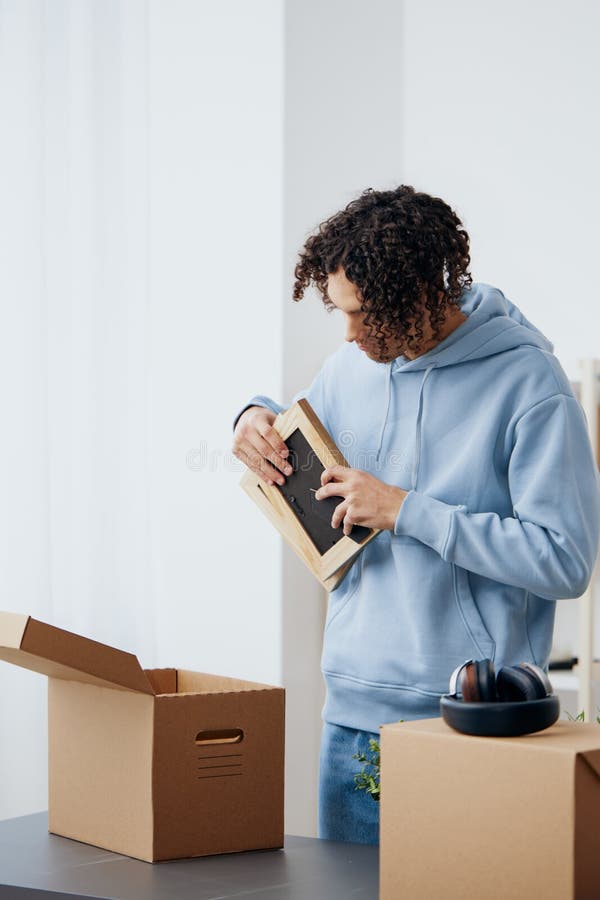 A Young Man Cardboard Boxes in the Room Unpacking Sorting Things Out ...