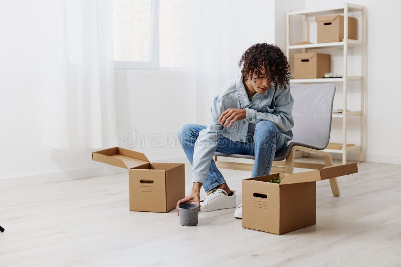 A Young Man Cardboard Boxes in the Room Unpacking Sorting Things Out ...