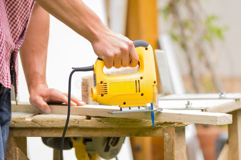 Young Man Carpenter Working with Electric Jigsaw Stock Image - Image of ...