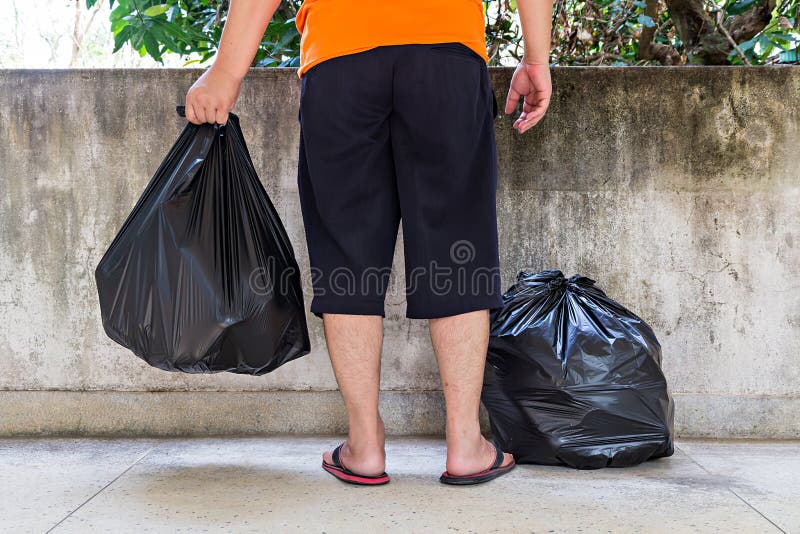 Young Man Carrying Garbage Bag Stock Image - Image of person, floor ...