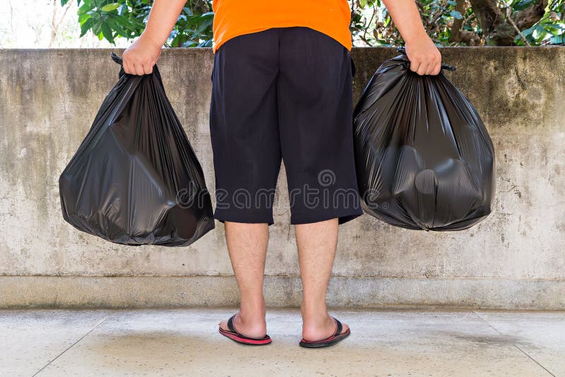 A Young Man Carrying Garbage Bags Stock Image - Image of adult, full ...