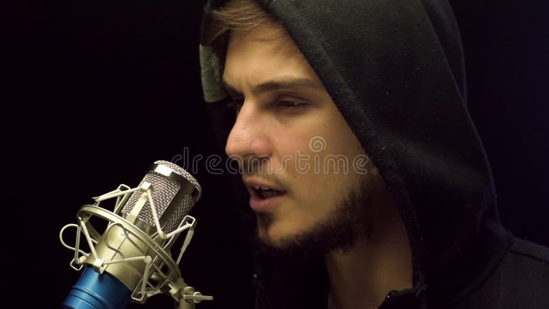 Young Man in Casual Cloth Standng Behind Microphone and Making Speech ...