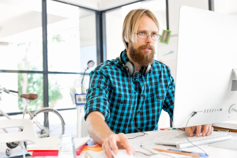 Young Man Working in Office Stock Photo - Image of sitting, portrait ...