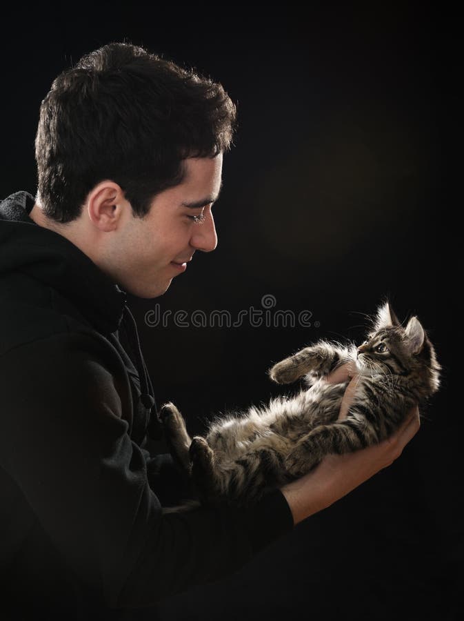 Young man with cat stock photo. Image of people, handsome - 18562898
