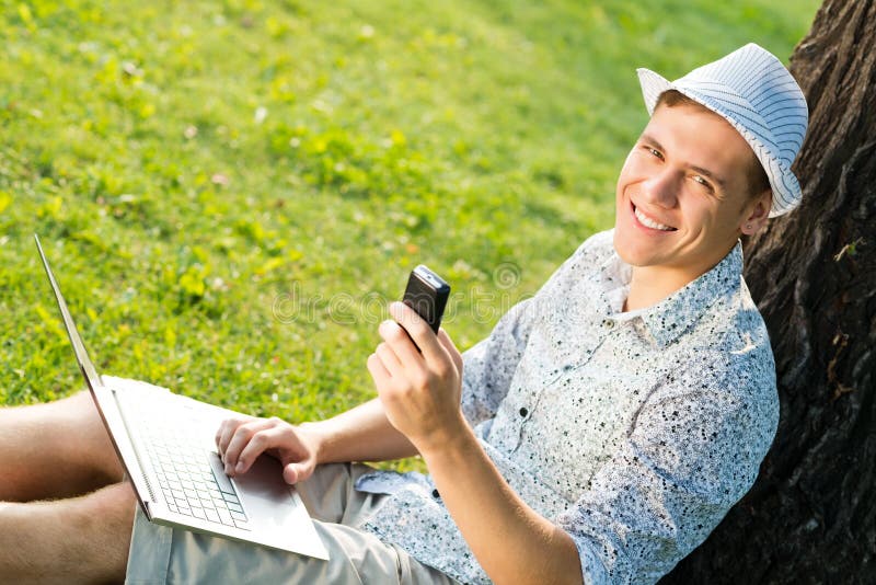 Young Man with a Cell Phone Stock Image - Image of people, outdoors ...