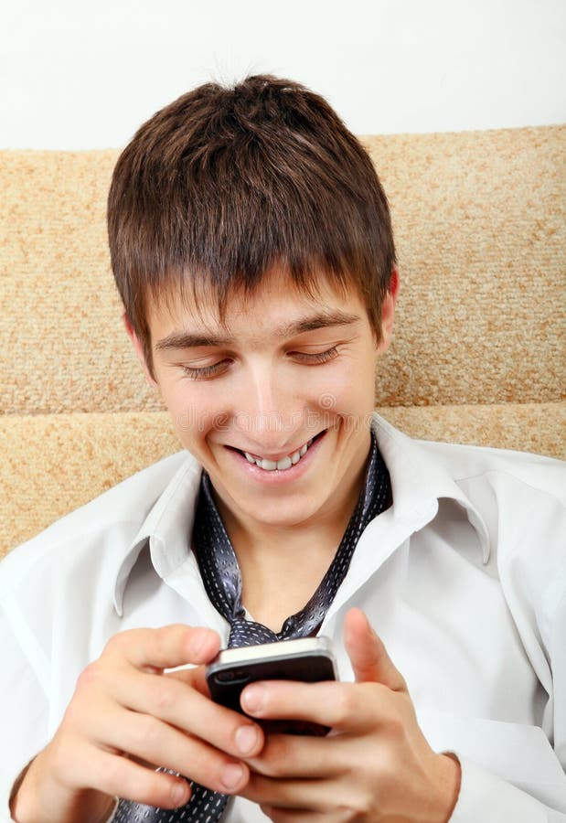 Young Man with Cellphone stock photo. Image of indoor - 54775778