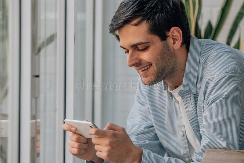 Man Chatting or Playing Games at Home or Office with Mobile Phone Stock ...