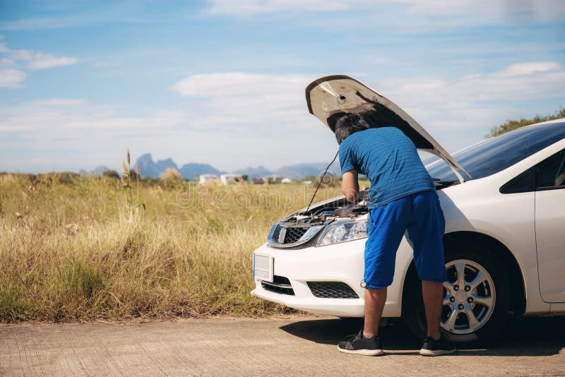 Young man is checking cars stock photo. Image of damage - 149496842