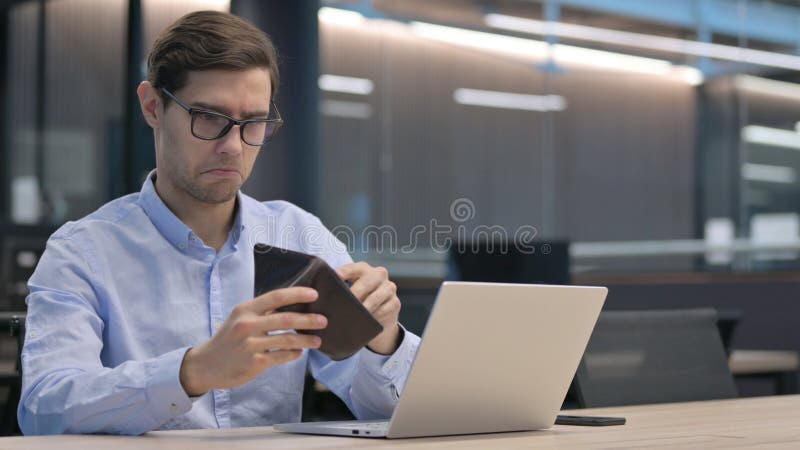 Young Man Checking Empty Wallet in Office Stock Photo - Image of ...