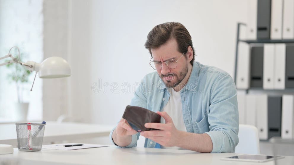 Young Man Checking Empty Wallet at Work Stock Photo - Image of finance ...