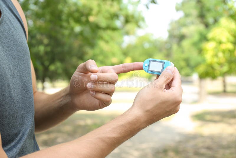 Young Man Checking Pulse with Device after Training, Closeup Stock ...