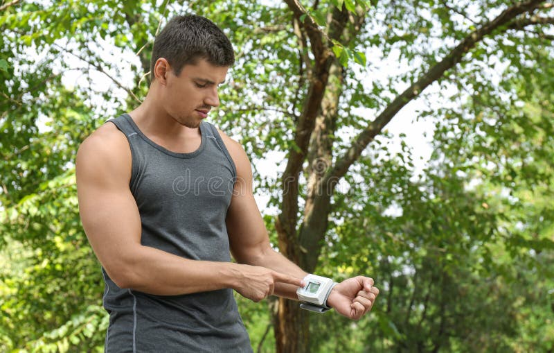 Young Man Checking Pulse Medical Device after Training Outdoors Stock ...