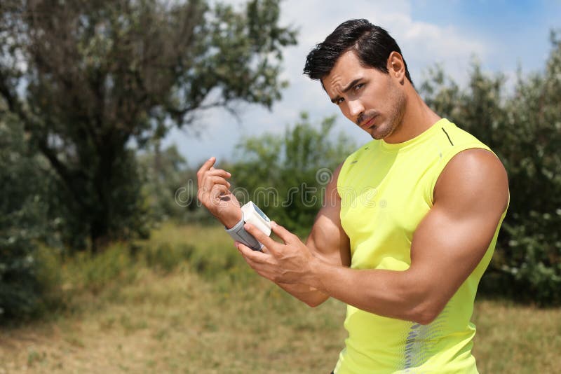 Young Man Checking Pulse with Medical after Training in Park Stock ...