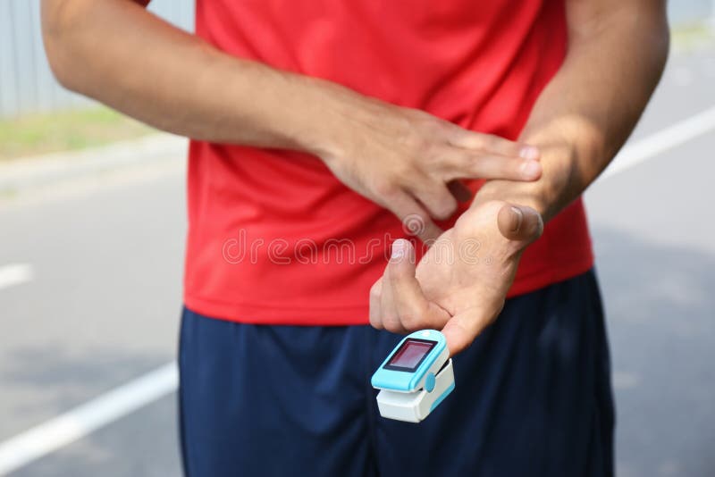 Young Man Checking Pulse with Medical Device after Training Stock Image ...