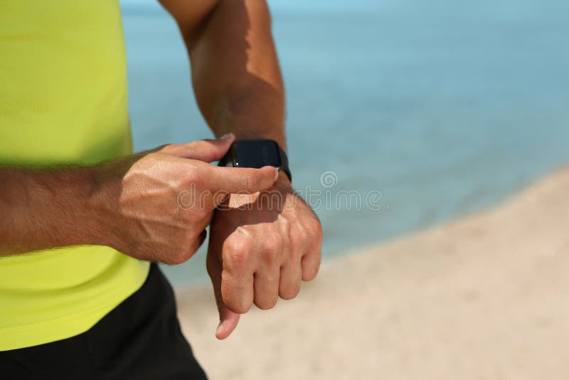 Young Man Checking Pulse with after Training on Beach, Closeup. Space ...