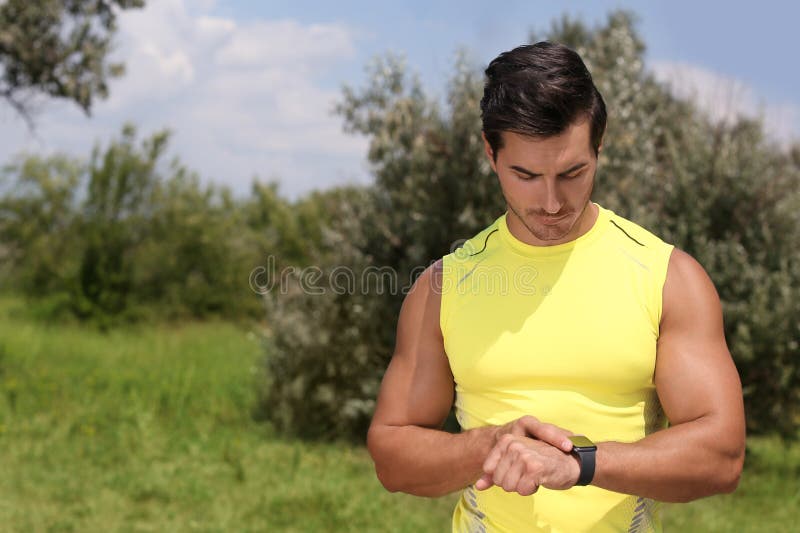 Young Man Checking Pulse with after Training in Park. Space for Text ...