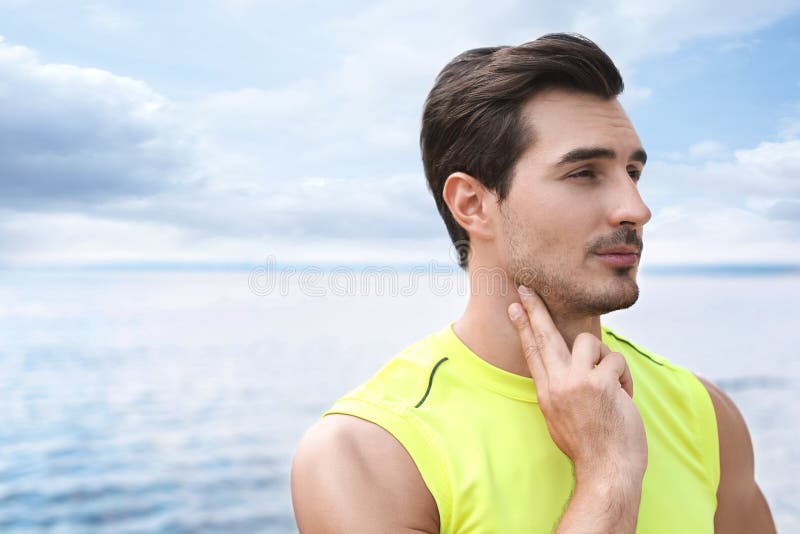 Young Man Checking Pulse after on Beach. Space for Text Stock Image ...