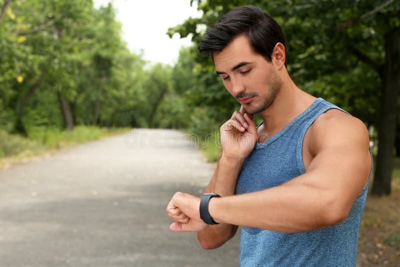 Young Man Checking Pulse after Training in Park Stock Photo - Image of ...