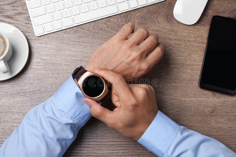 Young Man Checking Smart Watch at Workplace Stock Image - Image of ...