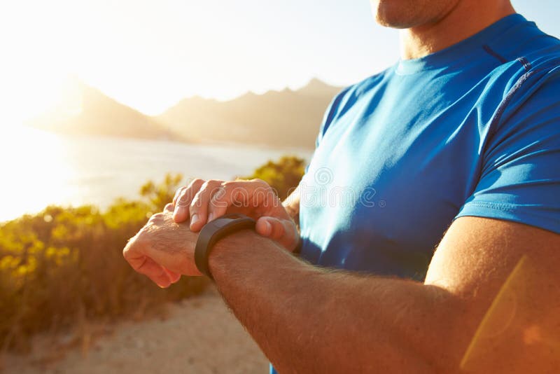 Young Man Checking Time on His Sports Watch Stock Image - Image of lens ...