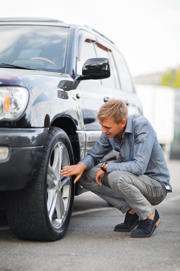 A Young Man Checks a Used Car. Used Car Theme. Stock Photo - Image of ...
