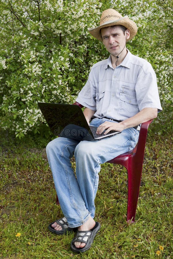 A Young Man in a Cherry Garden Stock Image - Image of spring, armchair ...