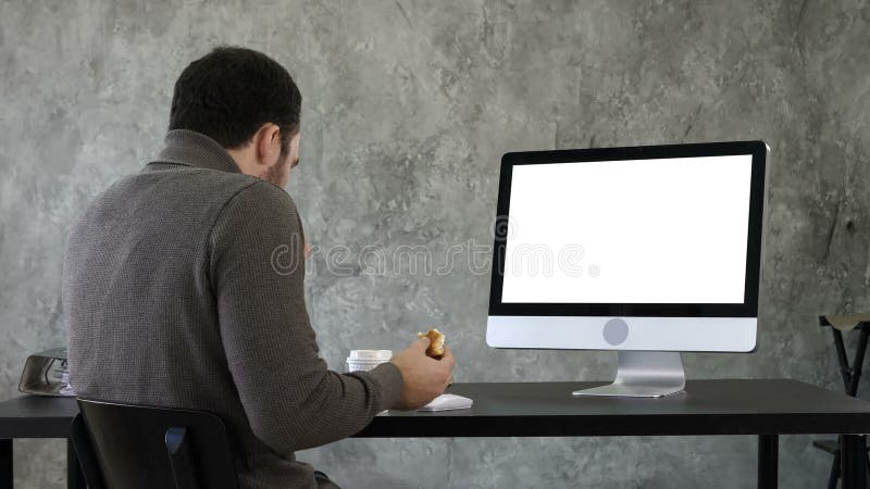 Young Man Choking while Eating and Watching Something on the Computer ...