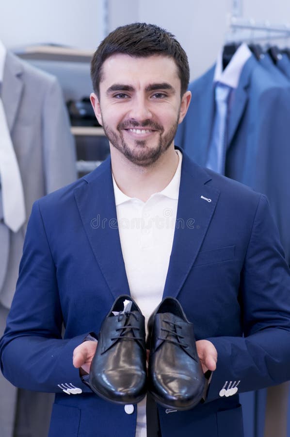 Young Man Chooses a Shoes at a Shop. Stock Photo - Image of display ...