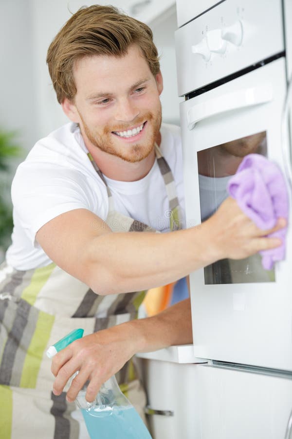 Young Man Cleaning Oven in Kitchen Stock Image - Image of service ...
