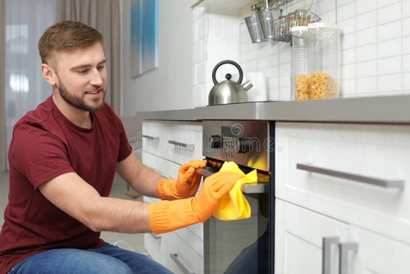 Man Cleaning Oven with Rag in Kitchen Stock Image - Image of adult ...