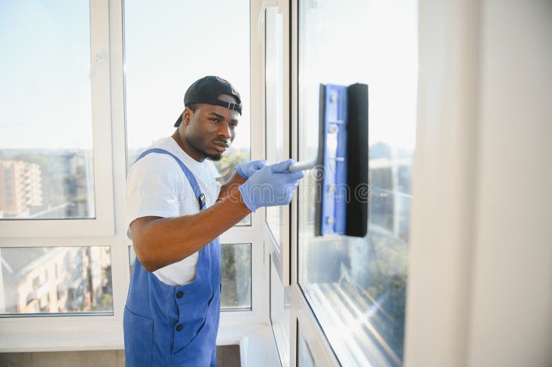 Young Man Cleaning Window in Office Stock Image - Image of domestic ...