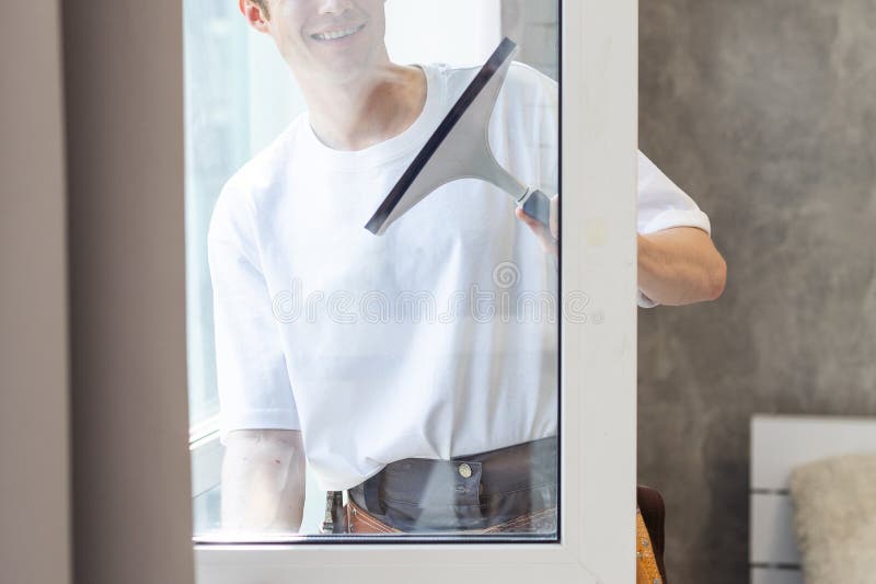 Young Man Cleaning Windows in the House Stock Photo - Image of person ...