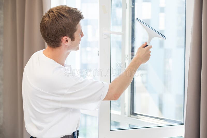 Young Man Cleaning Windows in the House Stock Image - Image of house ...