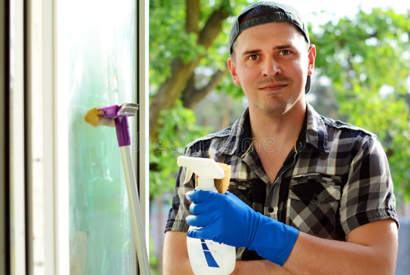 Blurred Focus of a Young Man Cleaning Window with Mop. Window Washer ...