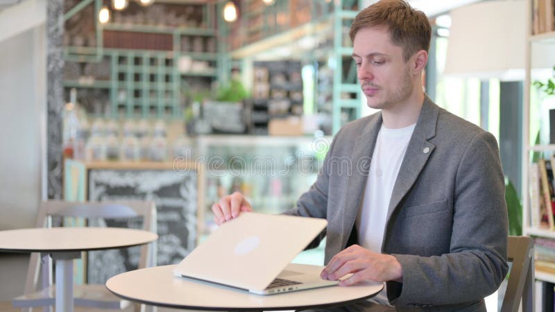 Young Man Closing Laptop and Going Away in Cafe Stock Photo - Image of ...