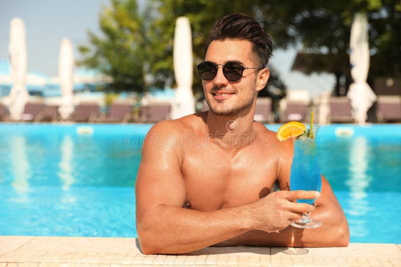 Young Man with Cocktail in Pool Stock Image - Image of resort, chest ...