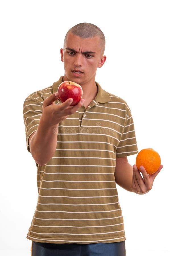 Young Man Comparing Apple To Orange Stock Image - Image of balance ...