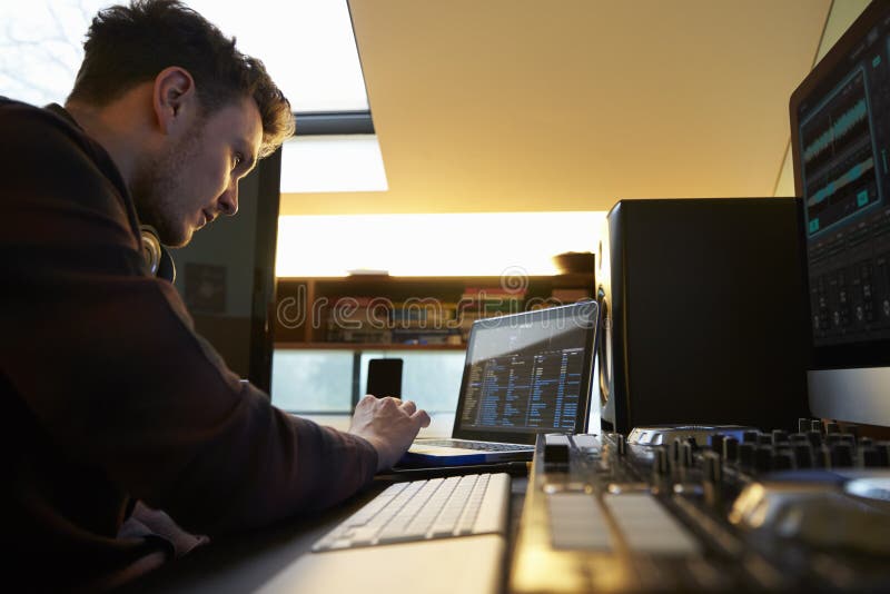 Young Man Composing Music on Laptop Computer in Bedroom Stock Image ...