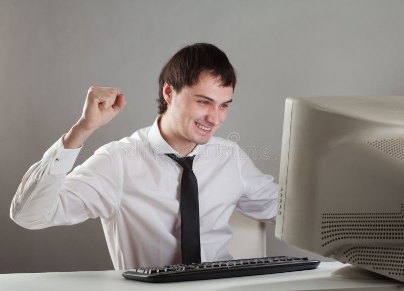Young man at the computer stock image. Image of display - 23205495