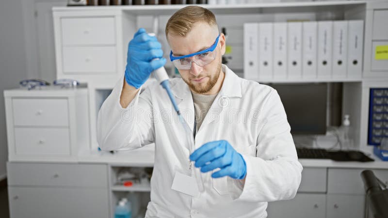 A Young Man Conducting an Experiment in a Laboratory Setting, Focused ...