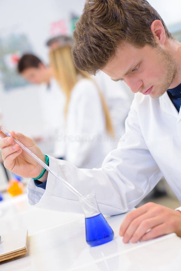 Young Man Conducting Scientific Experiment Stock Photo - Image of ...