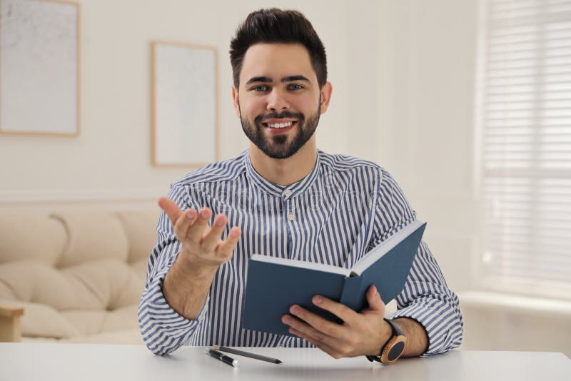Young Man Conducting Webinar at Desk in Room Stock Image - Image of ...