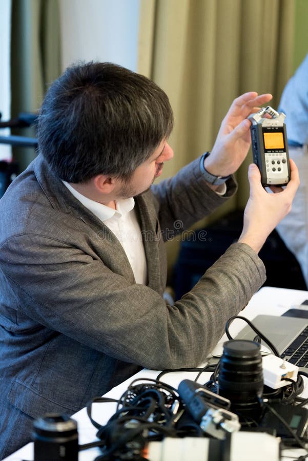 Young Man at Conference with Camera Stock Photo - Image of computer ...