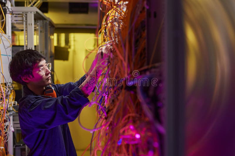 Young Man Connecting Cables in Server Room Stock Image - Image of data ...