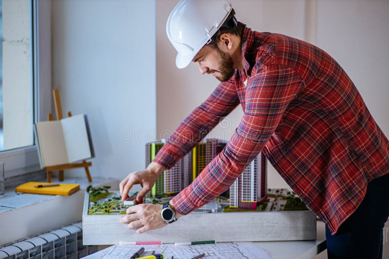Young Man Constructs a New High-rise Building Stock Image - Image of ...