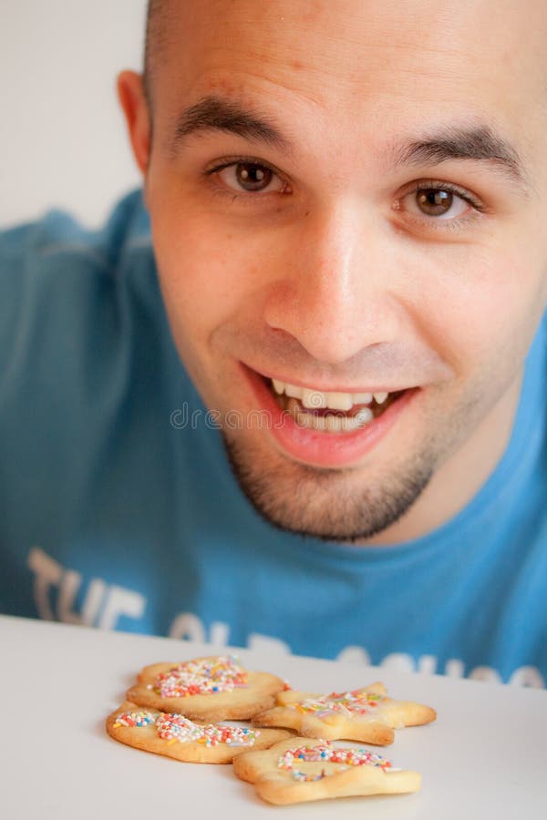 Young man with cookies stock photo. Image of eyes, shirt - 17339270