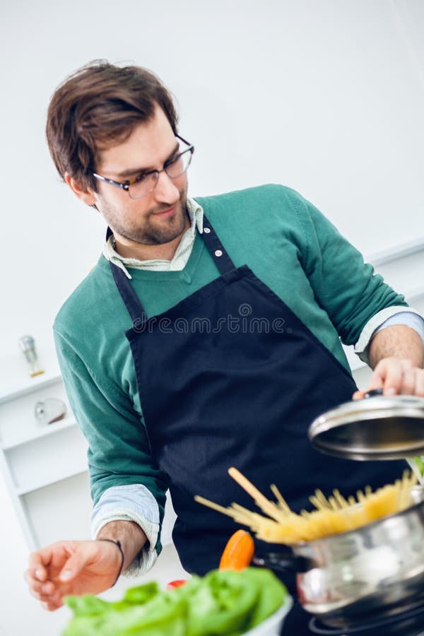 Young Man cooking stock photo. Image of indoors, cheerful - 41324550