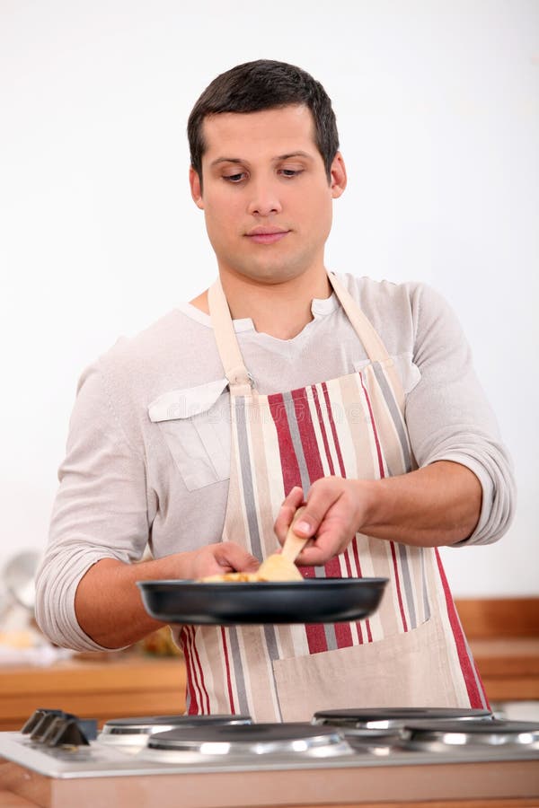 Young man cooking stock image. Image of pancakes, handsome - 35526295