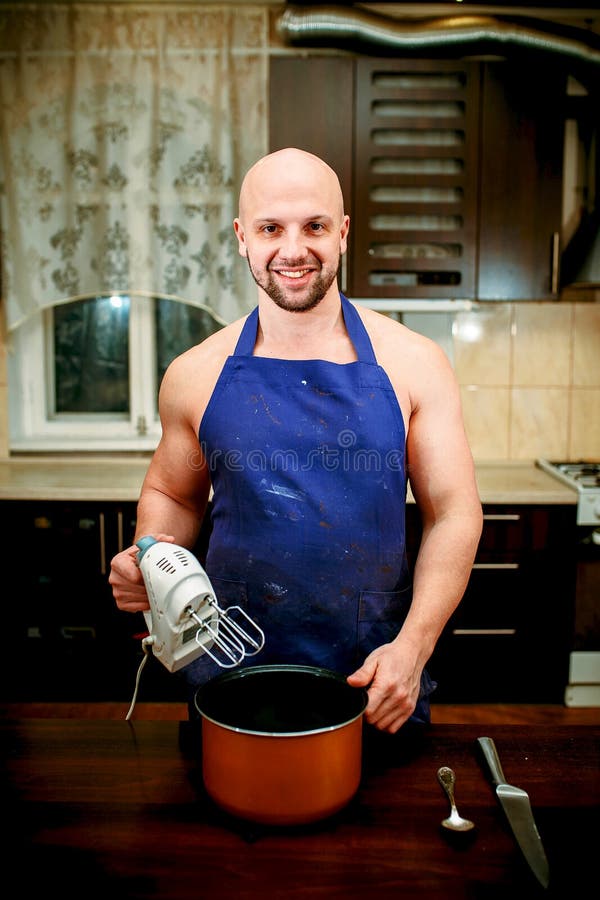 A Young Man is Cooking in a Large Kitchen Stock Image - Image of bowl ...