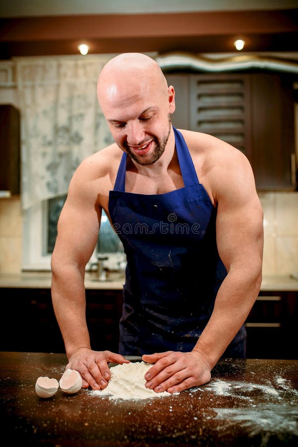 A Young Man is Cooking in a Large Kitchen Stock Photo - Image of back ...